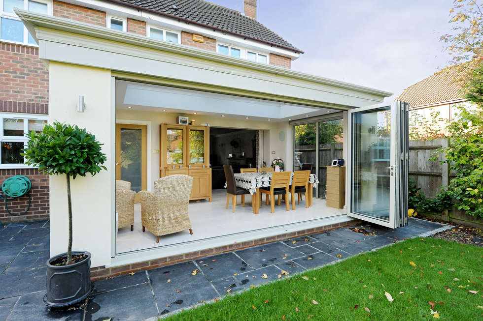 Aluminium orangery with bi fold doors: modern conservatory by rococo ...