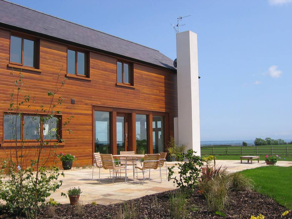 A modern take on the traditional farmstead form with a timber-clad ...