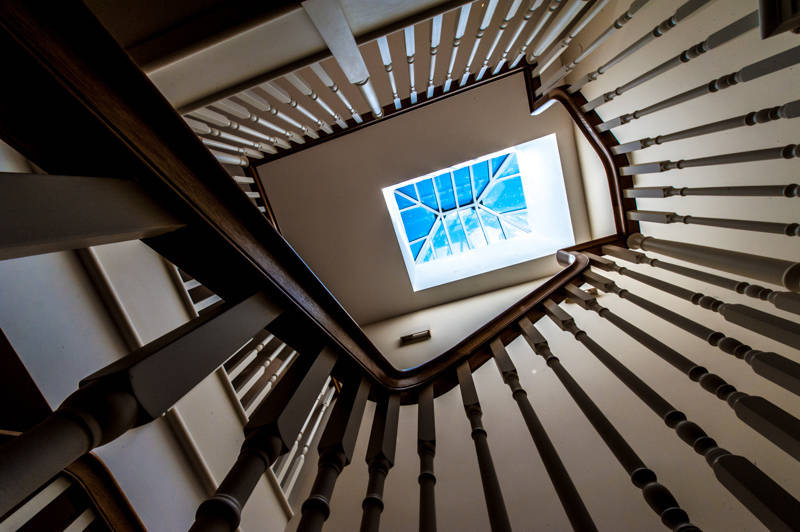 Traditional cut string painted staircase with an oak handrail and ...