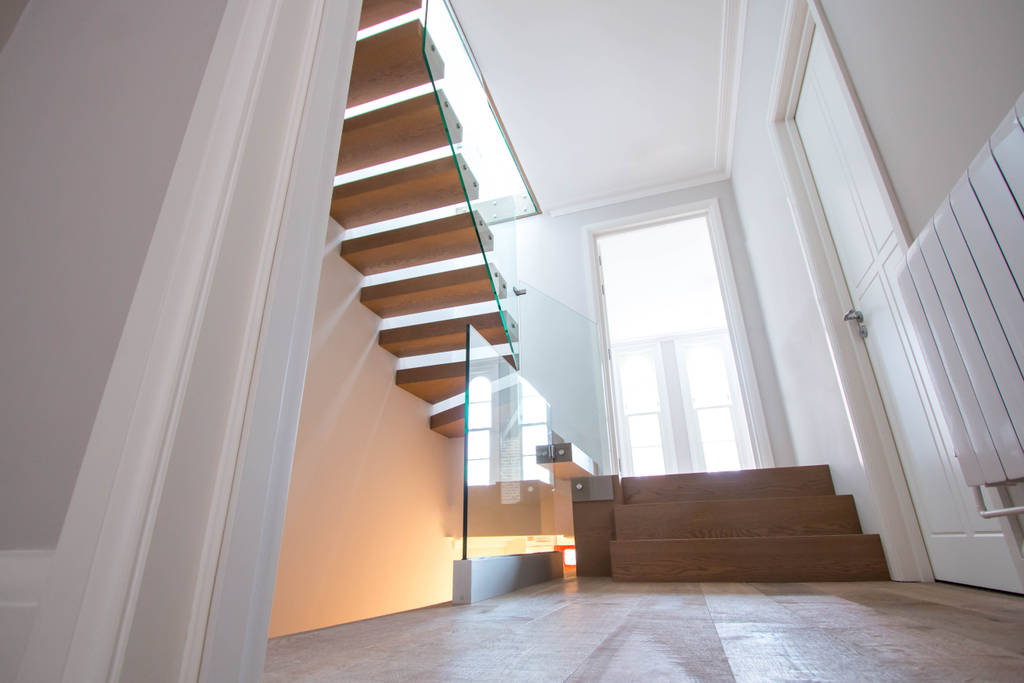 Custom-built cantilever staircase with oak-clad treads and frameless ...