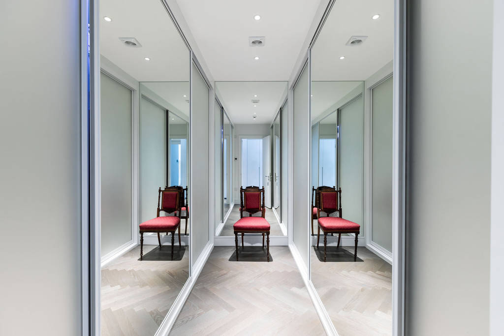 Bespoke walk-in wardrobe with sliding mirror panels | homify